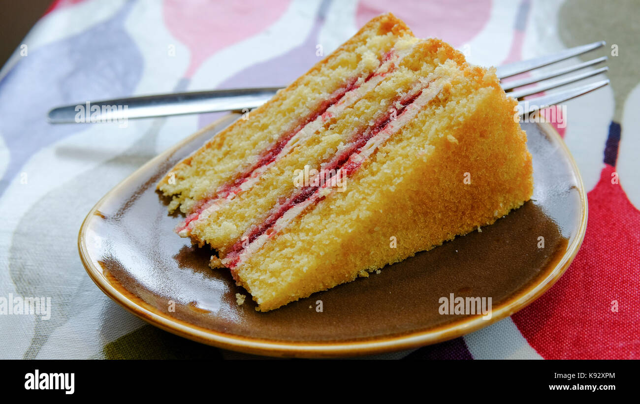 Slice of Victoria Sponge cake on plate Stock Photo - Alamy