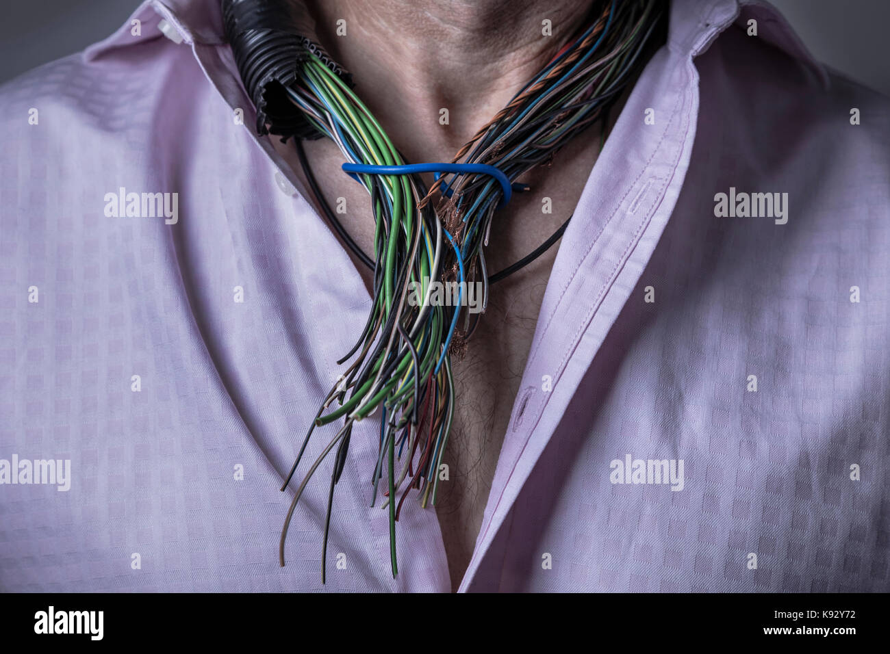 A man wearing a necklace made from wires Stock Photo - Alamy