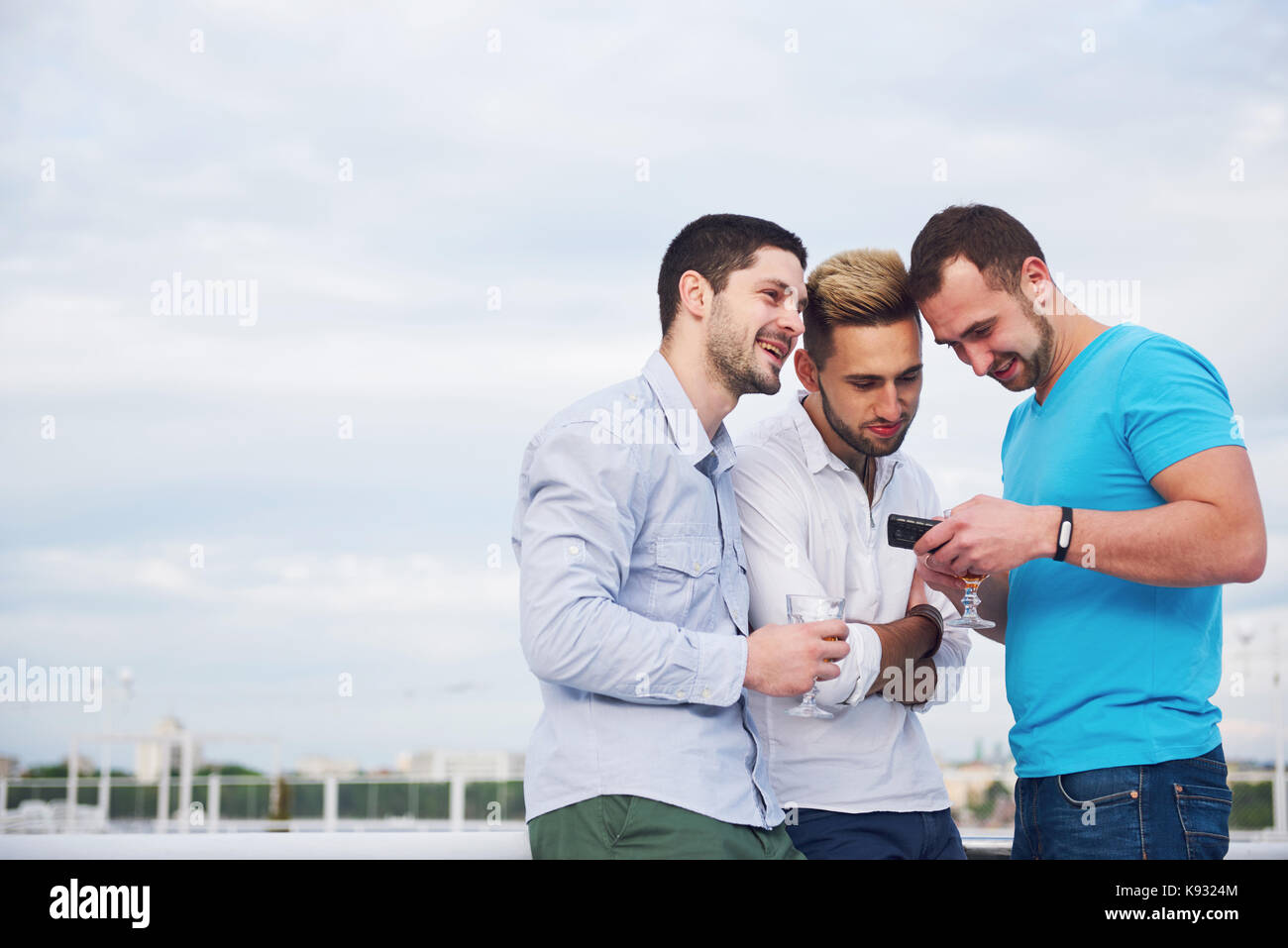A group of young and happy men on the pier Stock Photo - Alamy