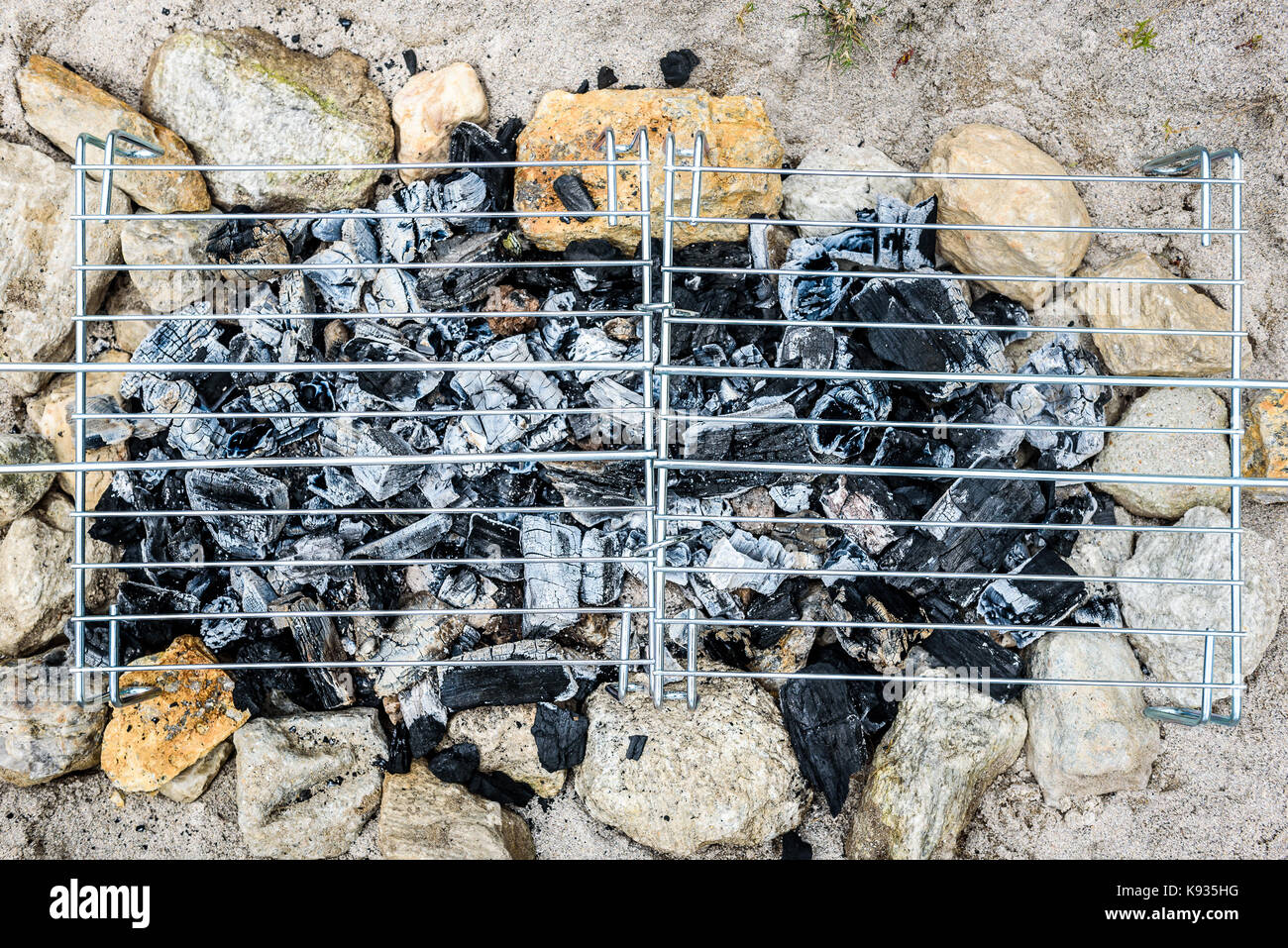 Homemade improvised BBQ barbecue grill on sandy beach on vacation ...