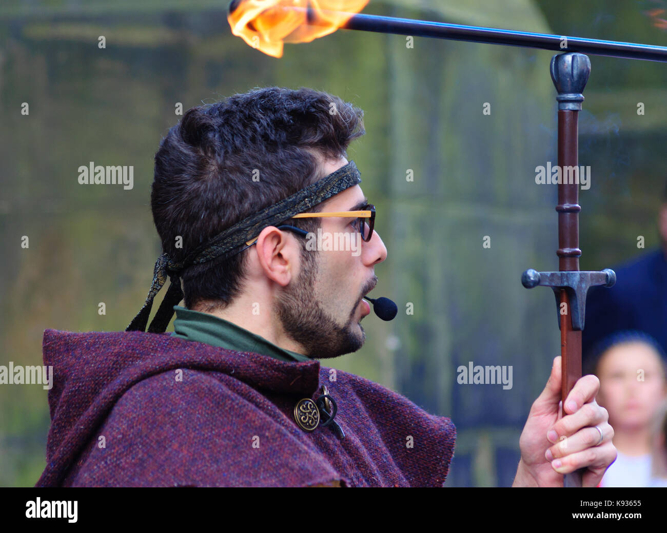 Male performer with sword and flaming torch on the Royal Mile during ...