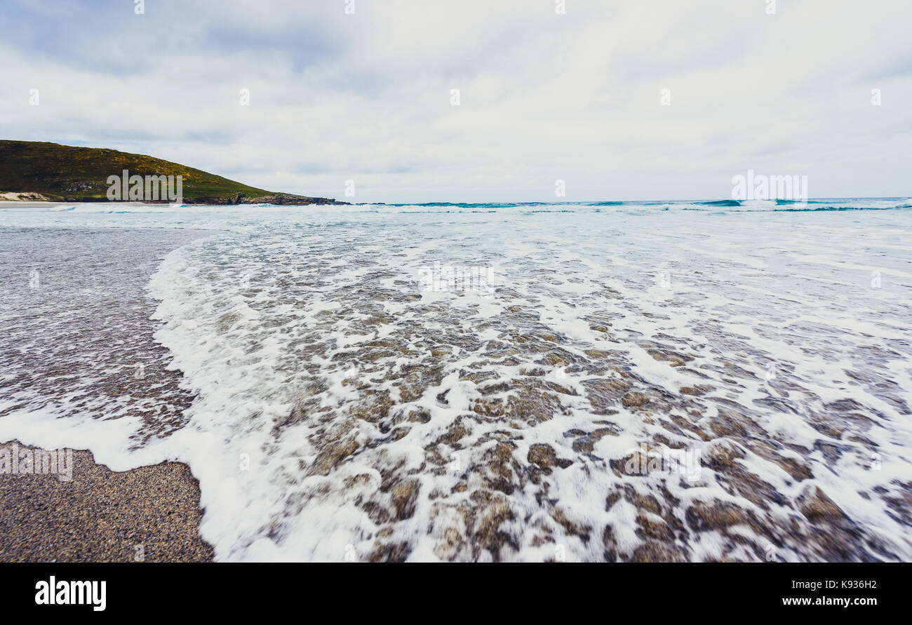 Small ocean sea waves on sandy beach in calm weather. Background ...