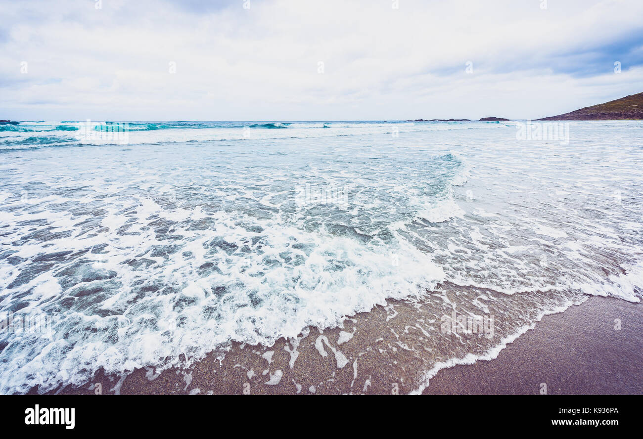 Small ocean sea waves on sandy beach in calm weather. Background ...