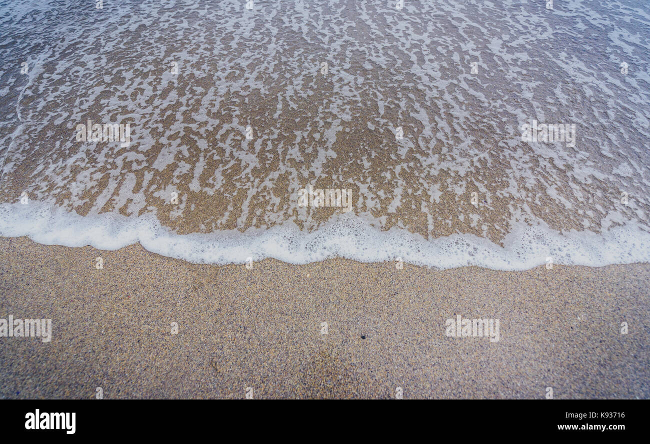 Small ocean sea waves on sandy beach in calm weather. Background ...