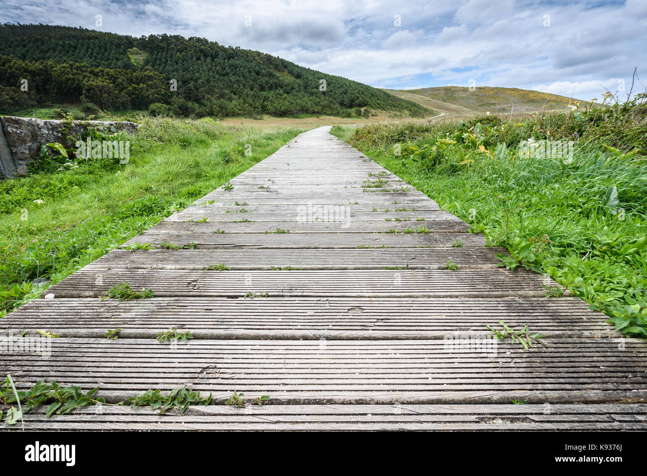 Bridge or pier over a dune on a sandy beach. Wooden bridge, pier made ...