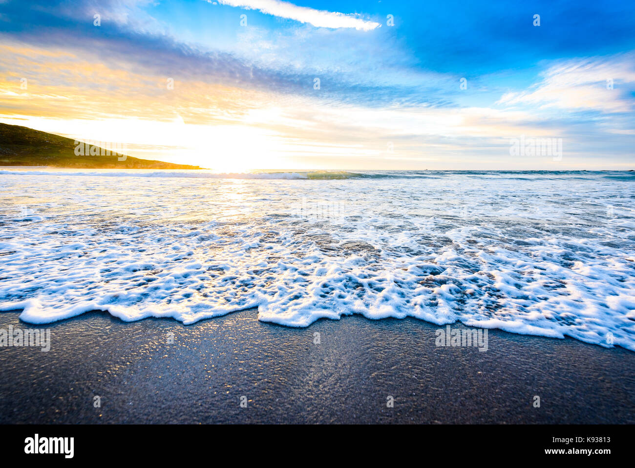 Small ocean sea waves on sandy beach with sunrise sunset. Background ...