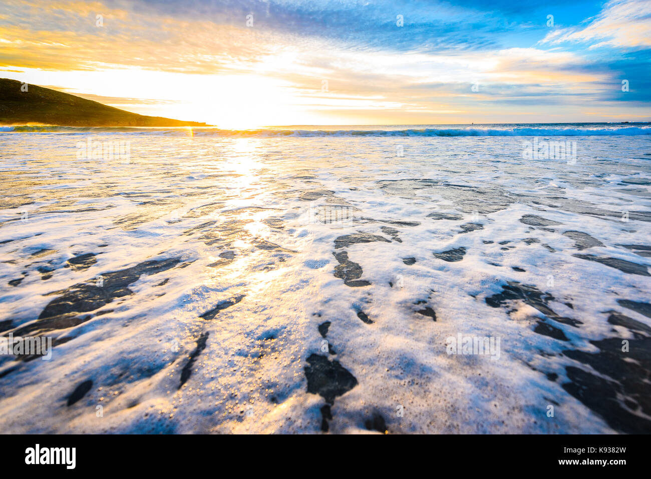 Small ocean sea waves on sandy beach with sunrise sunset. Background ...