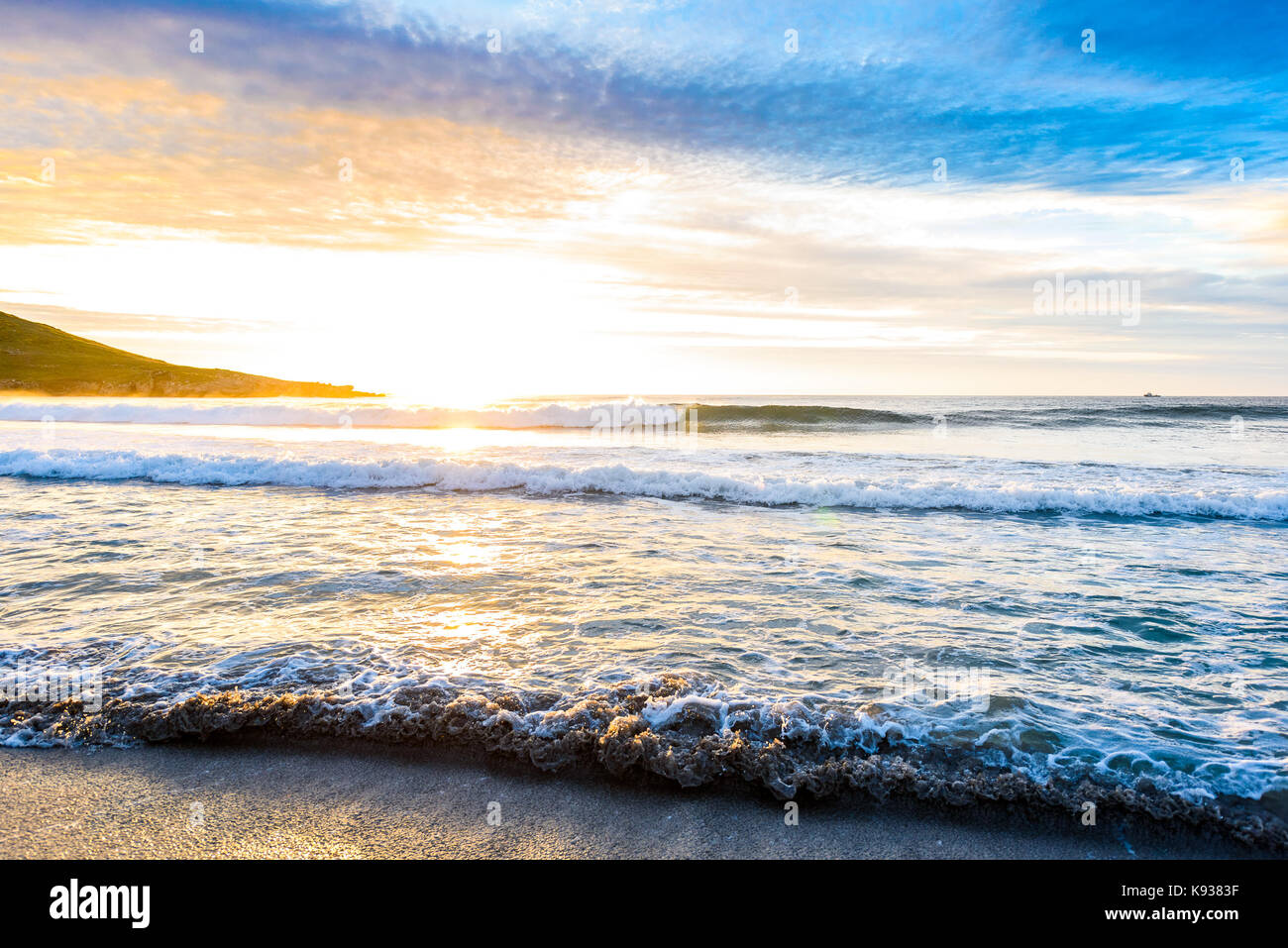 Small ocean sea waves on sandy beach with sunrise sunset. Background ...