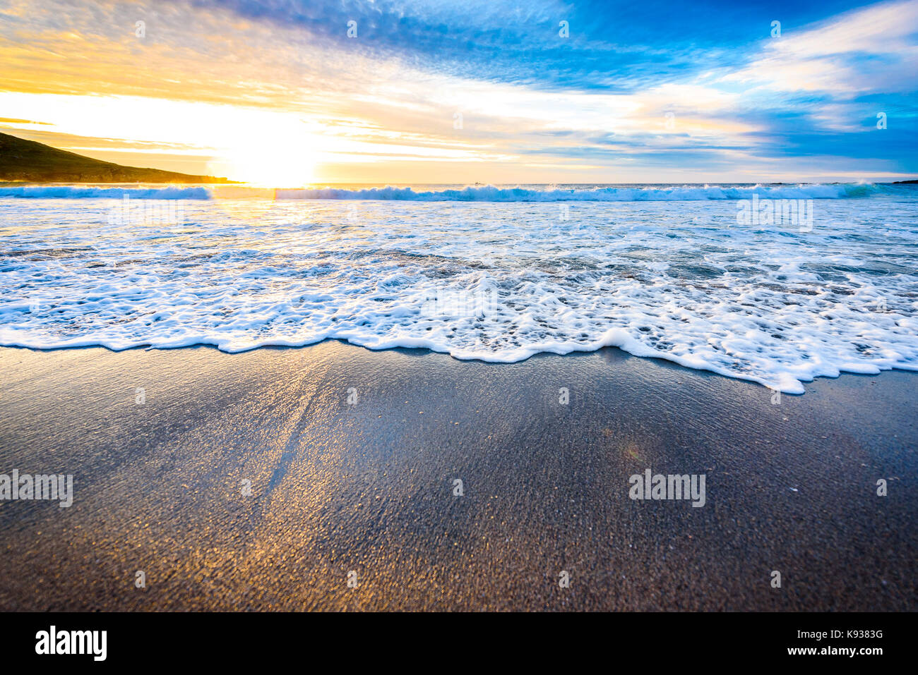 Small ocean sea waves on sandy beach with sunrise sunset. Background ...