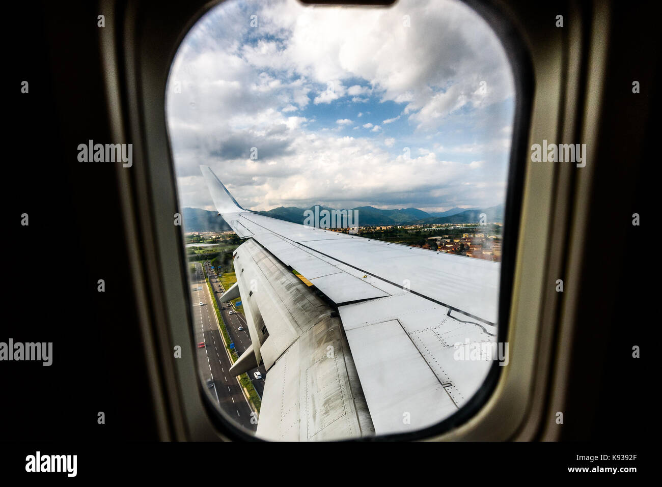 Looking trough window of an aircraft, airplane or plane wing. View from ...