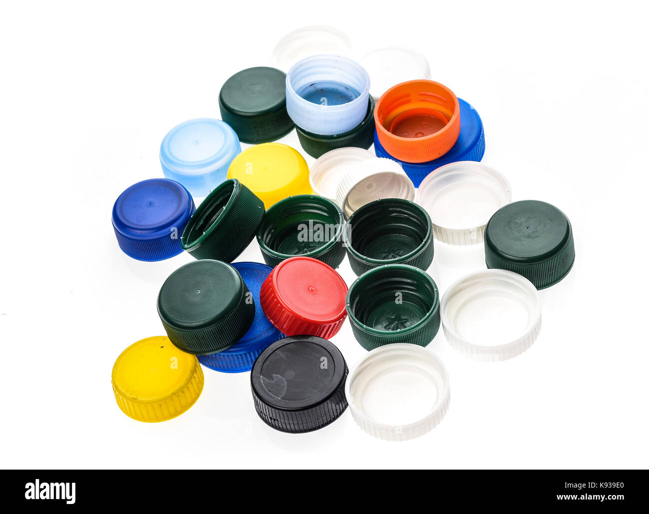 Plastic bottle caps in different colours. A pile of plastic bottle ...