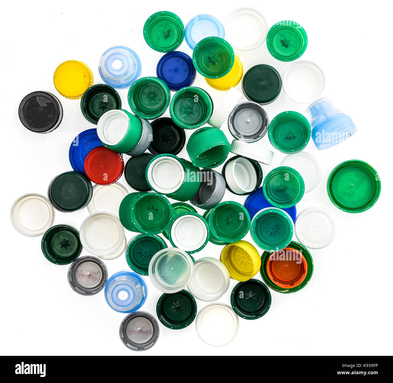 Plastic bottle caps in different colours. A pile of plastic bottle ...
