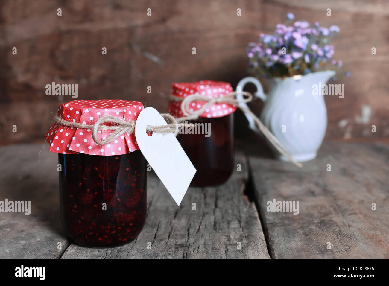 rustic homemade jam jar wooden background and flower Stock Photo - Alamy