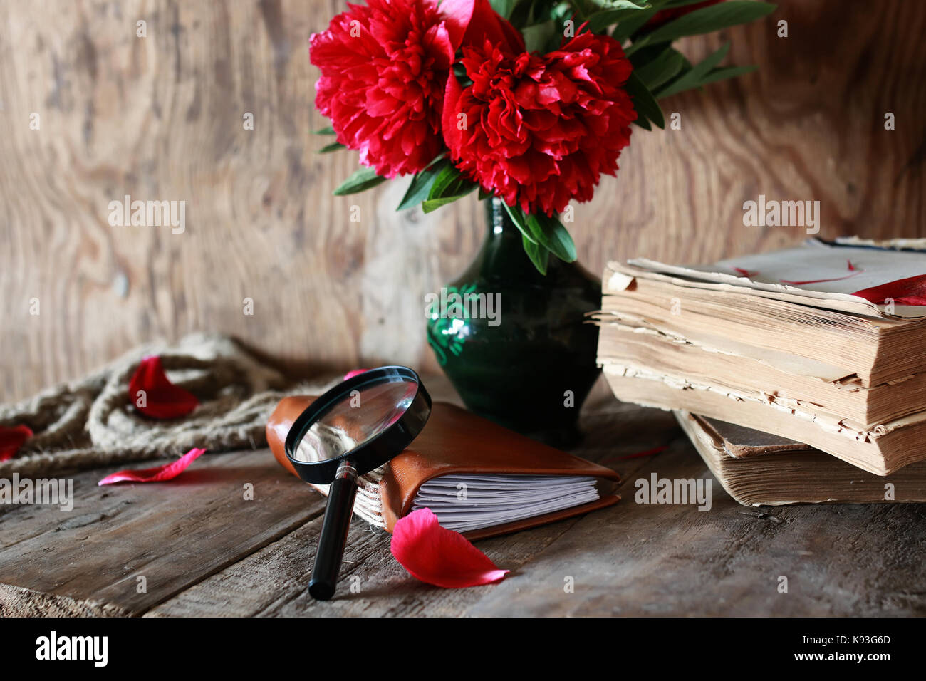 old book flower on wooden table Stock Photo - Alamy