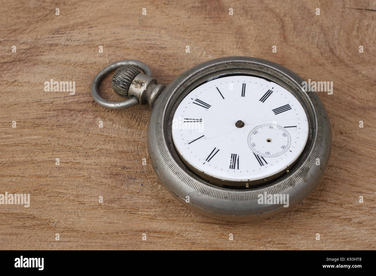 broken vintage pocket watch on wooden background Stock Photo - Alamy