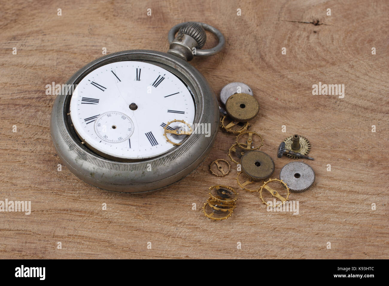 broken vintage pocket watch on wooden background Stock Photo - Alamy