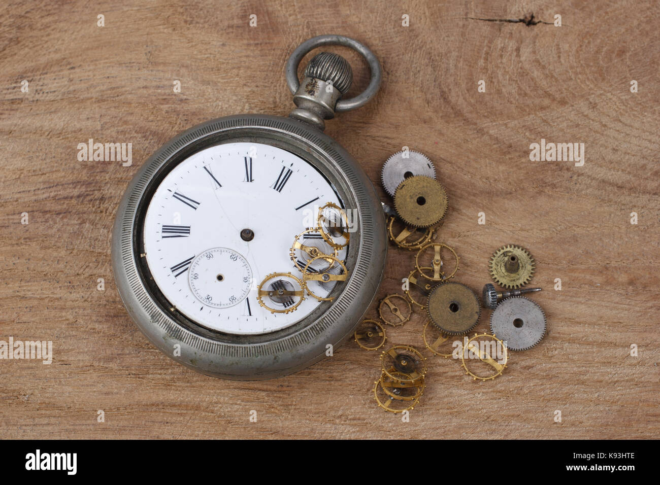 broken vintage pocket watch on wooden background Stock Photo - Alamy