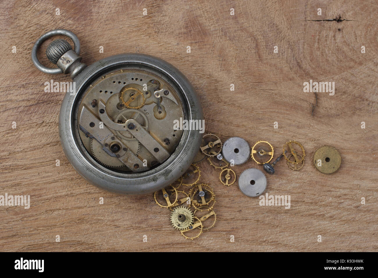 broken vintage pocket watch on wooden background Stock Photo - Alamy