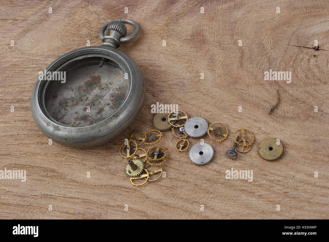 broken vintage pocket watch on wooden background Stock Photo - Alamy