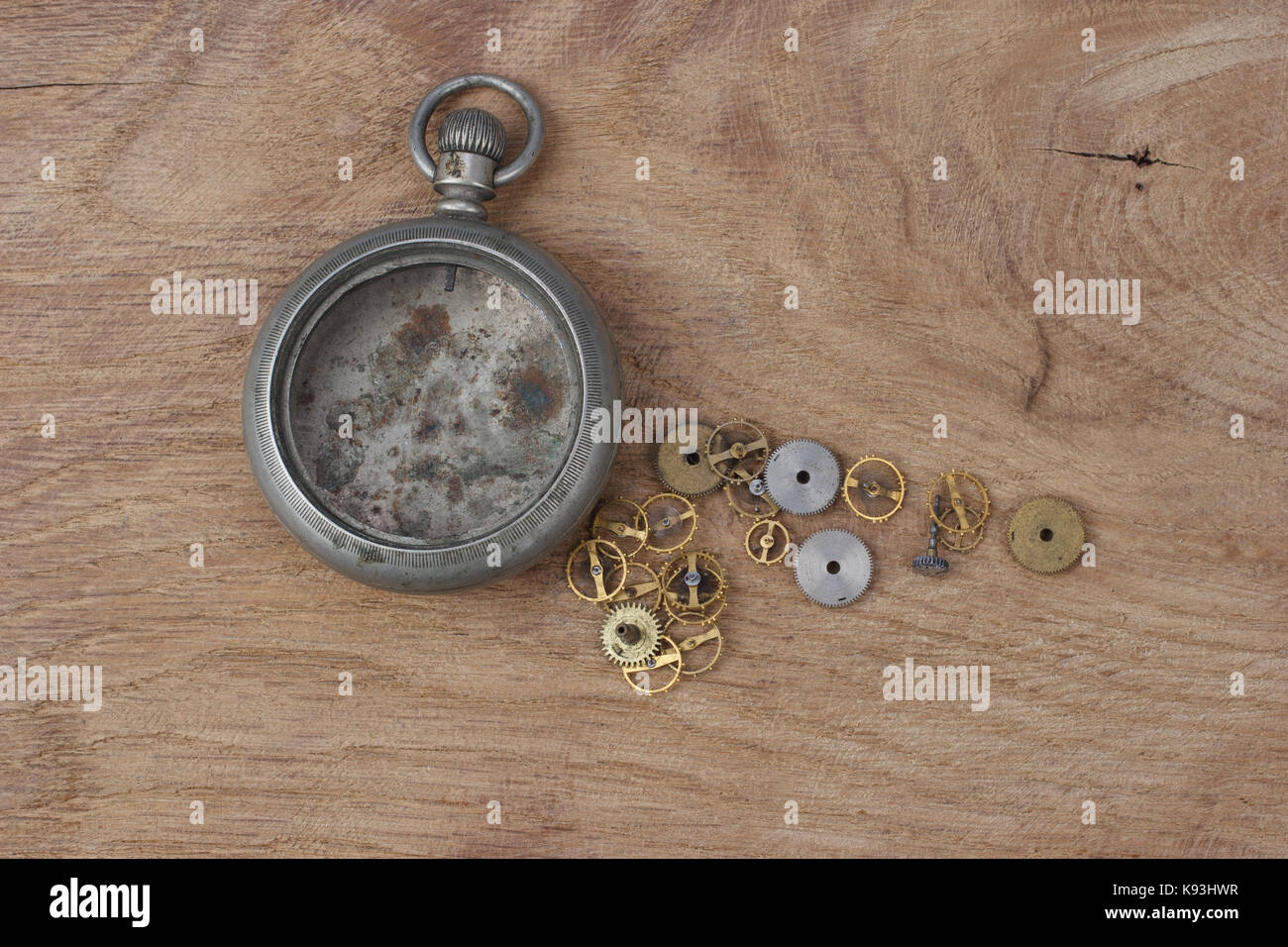 broken vintage pocket watch on wooden background Stock Photo - Alamy