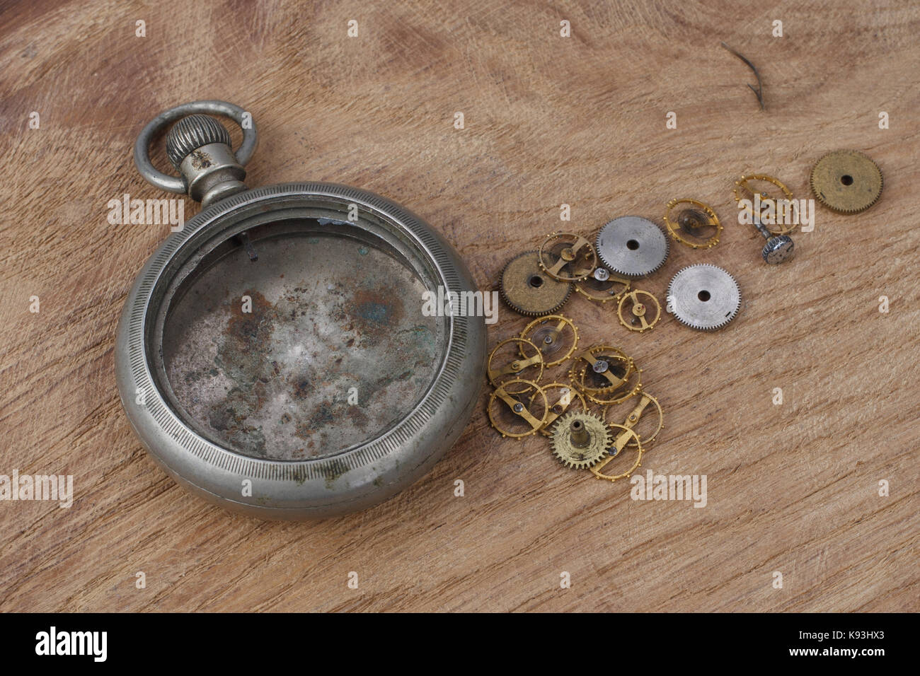 broken vintage pocket watch on wooden background Stock Photo - Alamy