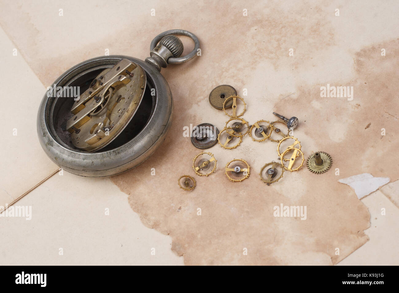 broken vintage pocket watch on dirty paper background Stock Photo - Alamy