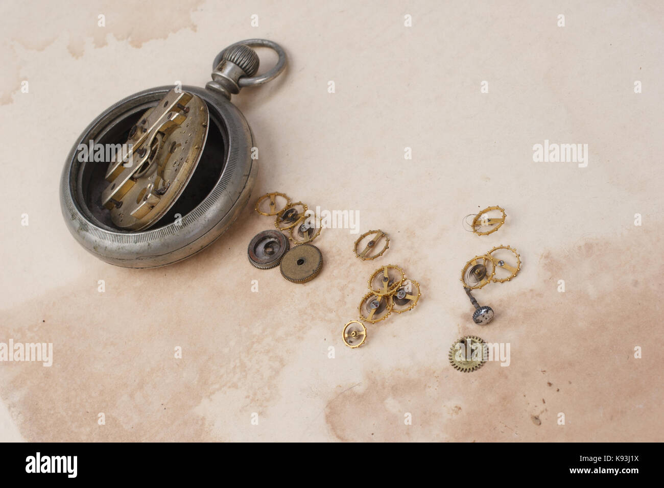 broken vintage pocket watch on dirty paper background Stock Photo - Alamy