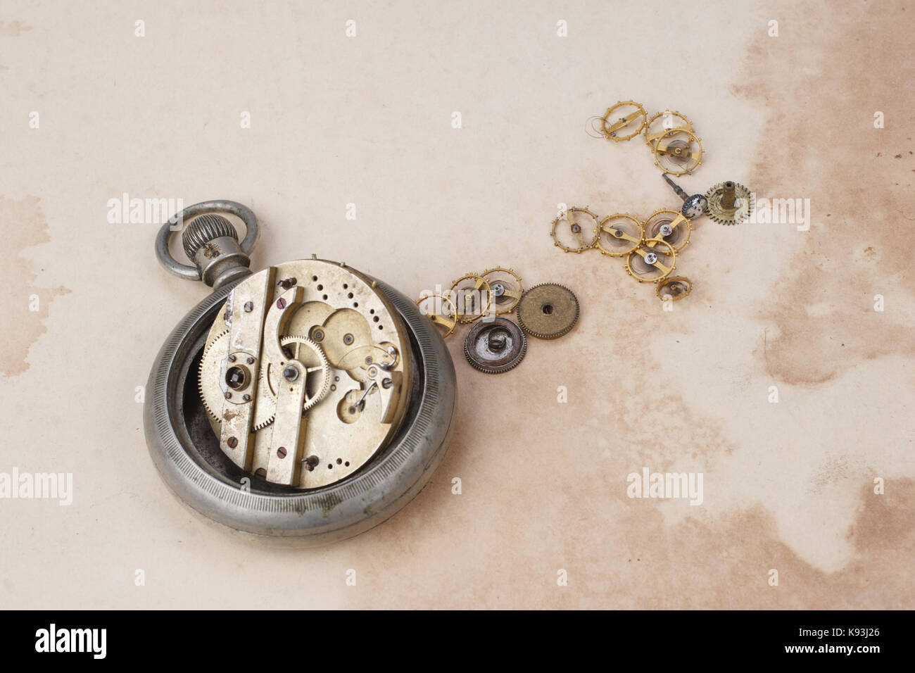 broken vintage pocket watch on dirty paper background Stock Photo - Alamy