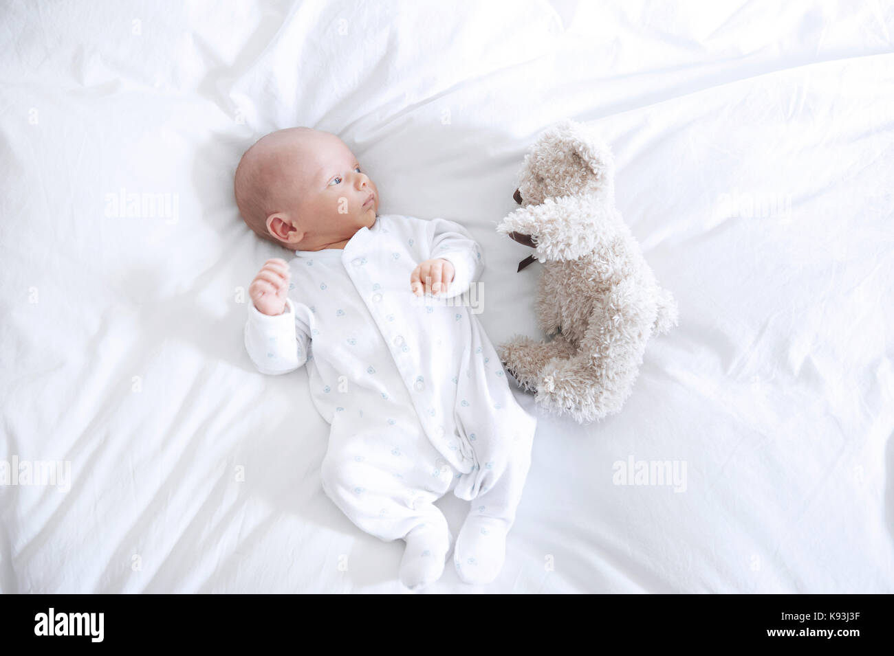 Close-up portrait of a very young newborn toddler wrapped in fresh ...
