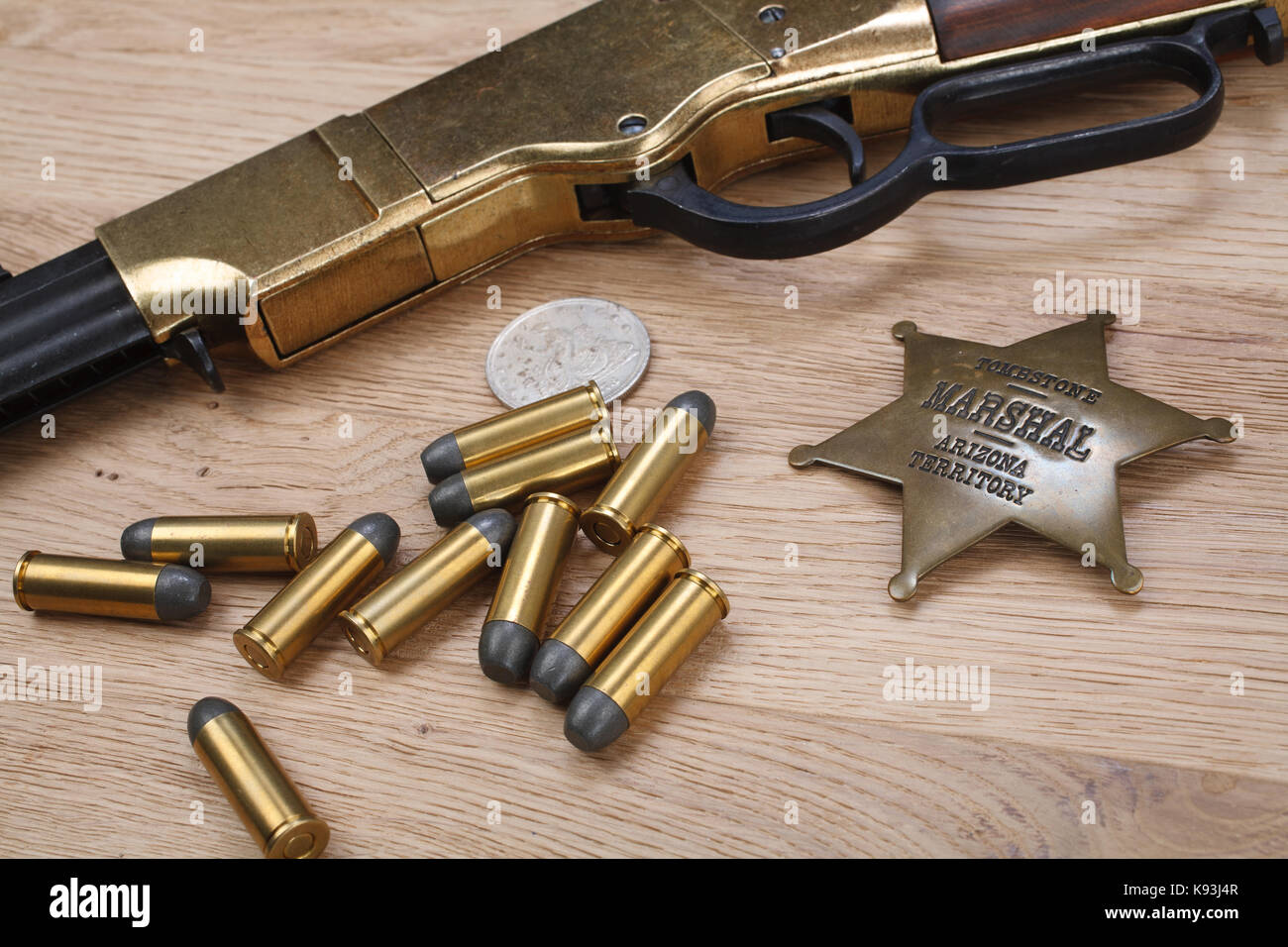 Wild west period repeating rifle with ammunition and sheriff badge ...