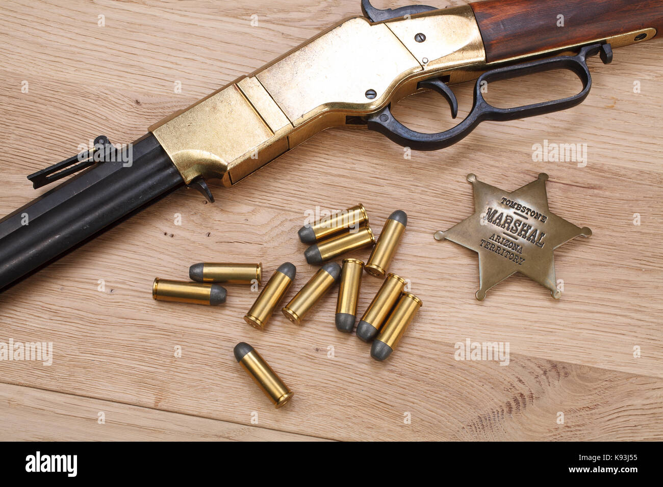 Wild west period repeating rifle with ammunition and sheriff badge ...