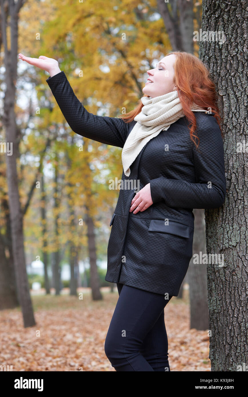 young woman stand near tree in autumn park, yellow leaves Stock Photo ...