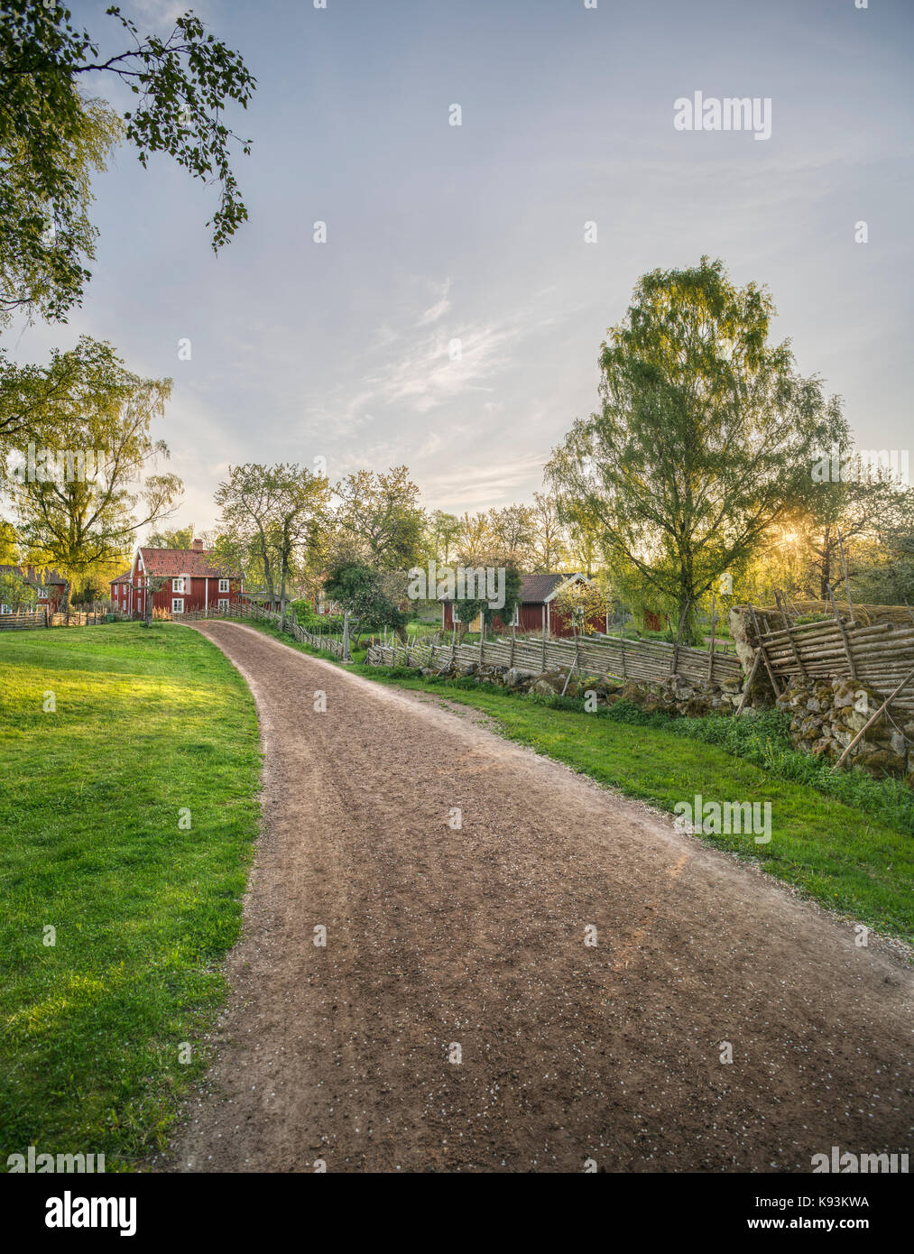 Sunrise at the old countryside village Stensjo By with roundpole fence ...