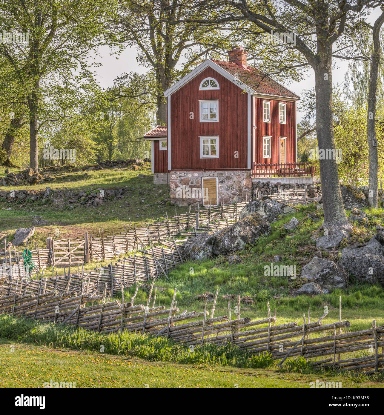 Old farm house and traditional roundpole fence in a rural landscape at ...