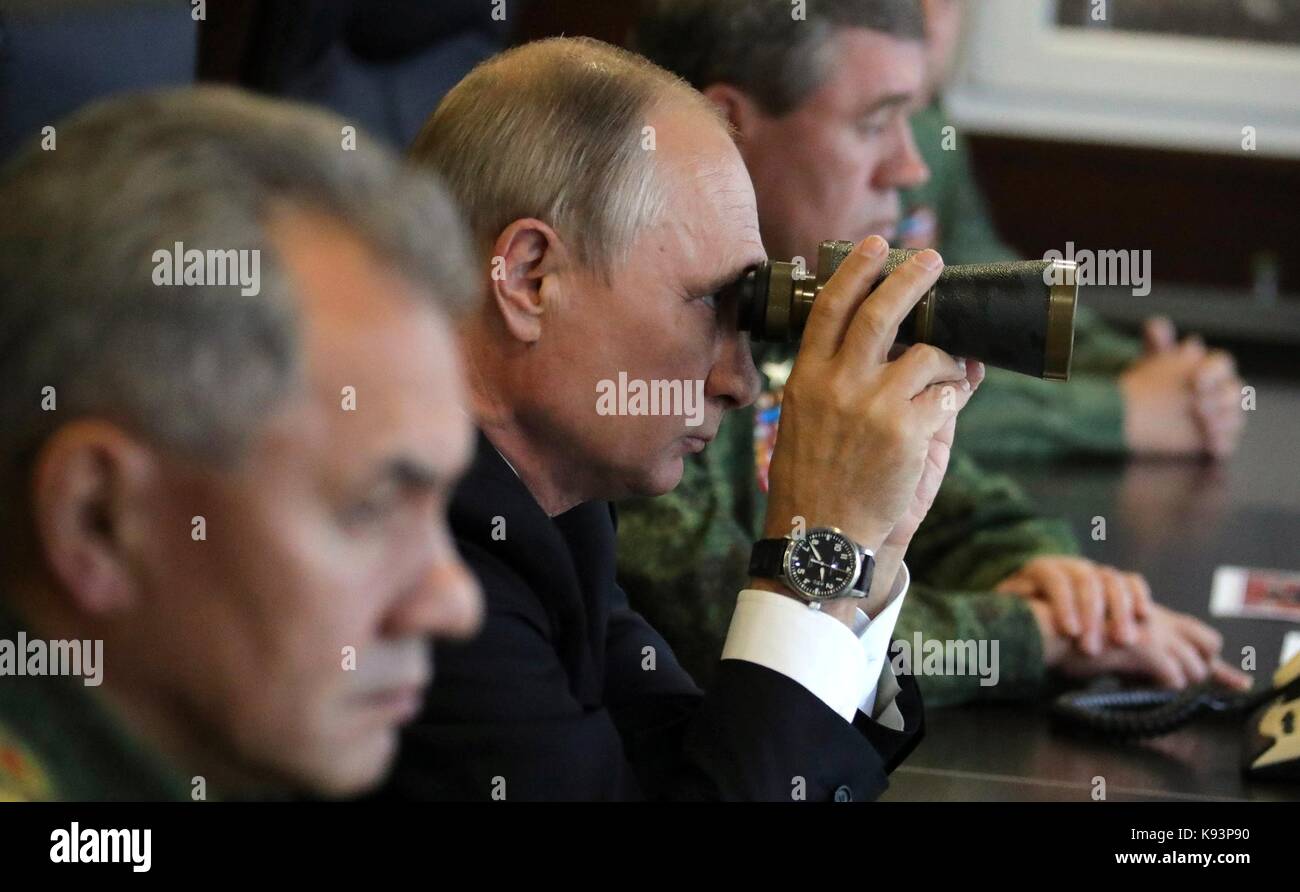 Russian President Vladimir Putin looks through binoculars as Russian ...