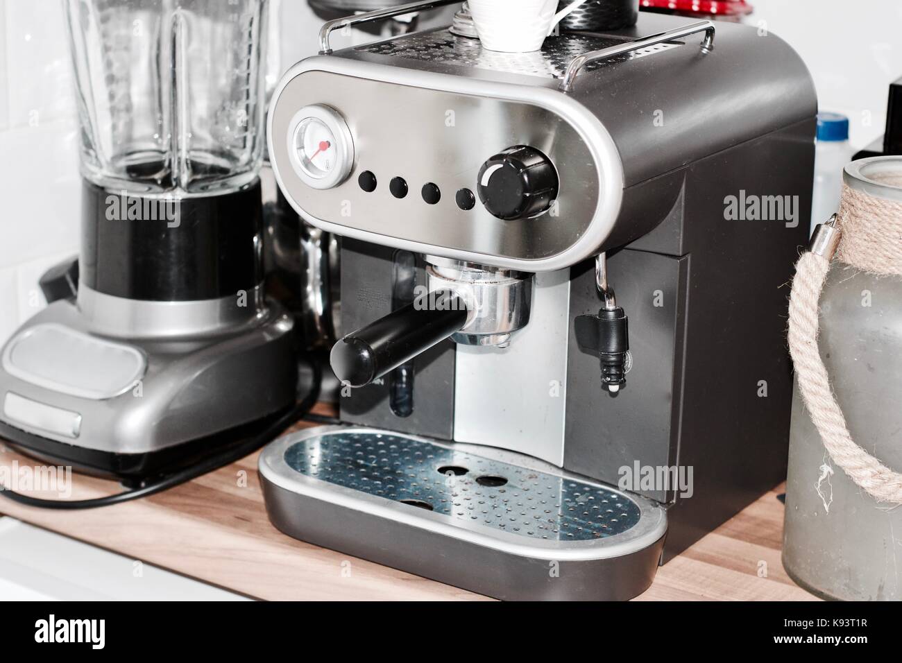 Big silver coffee machine in the kitchen near big glass jar and other ...