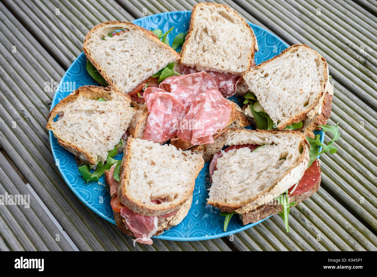 High angle close up of selection of sandwiches with coppa and salami on ...