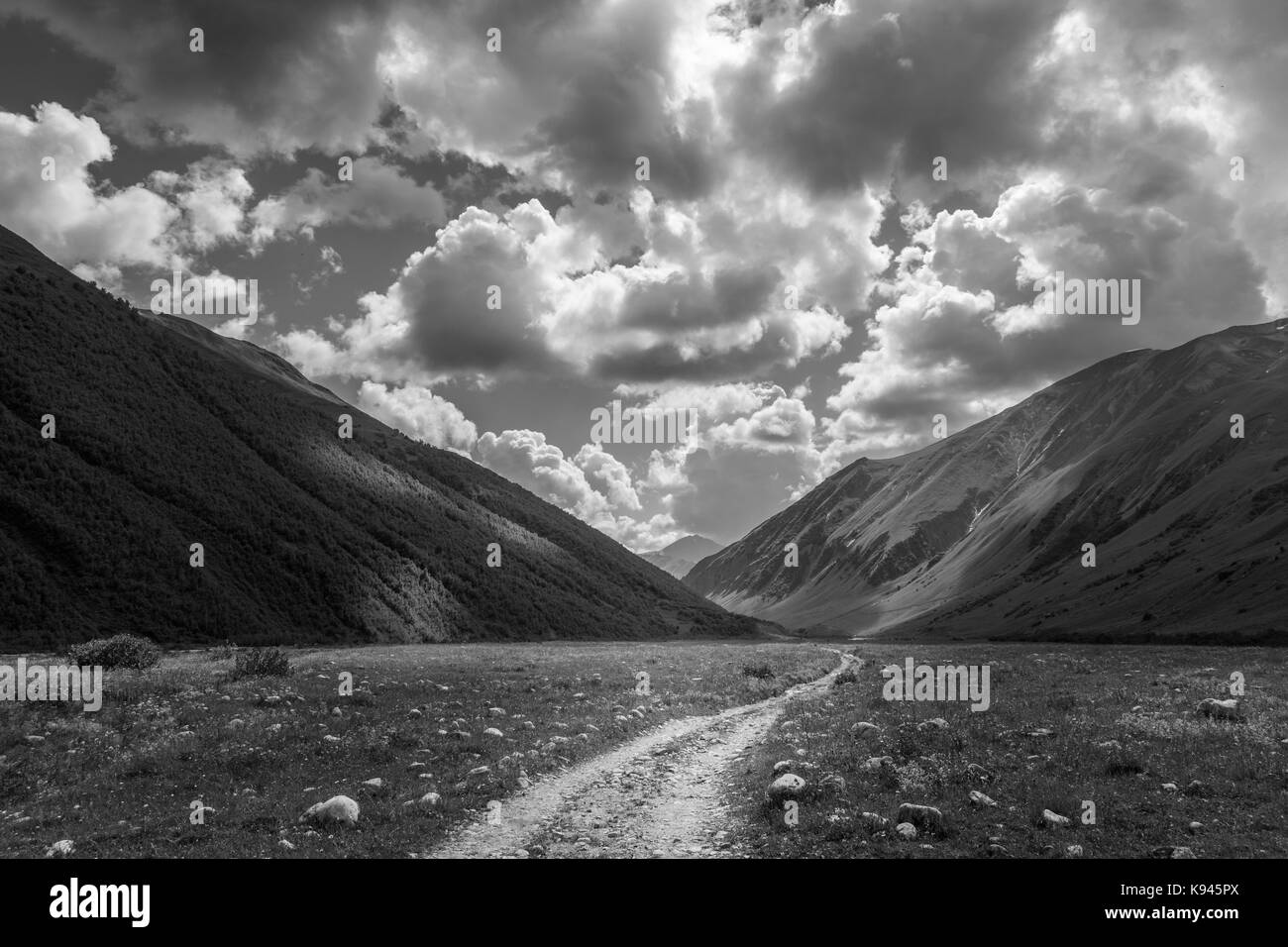 Mountainous landscape with rural path under a cloudy sky, Georgia Stock ...