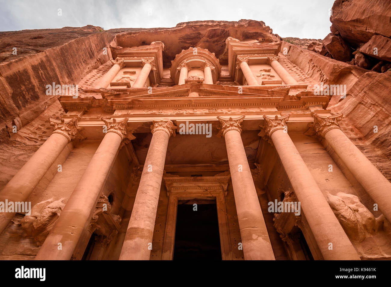 Low angle exterior view of the rock-cut architecture of Al Khazneh or ...