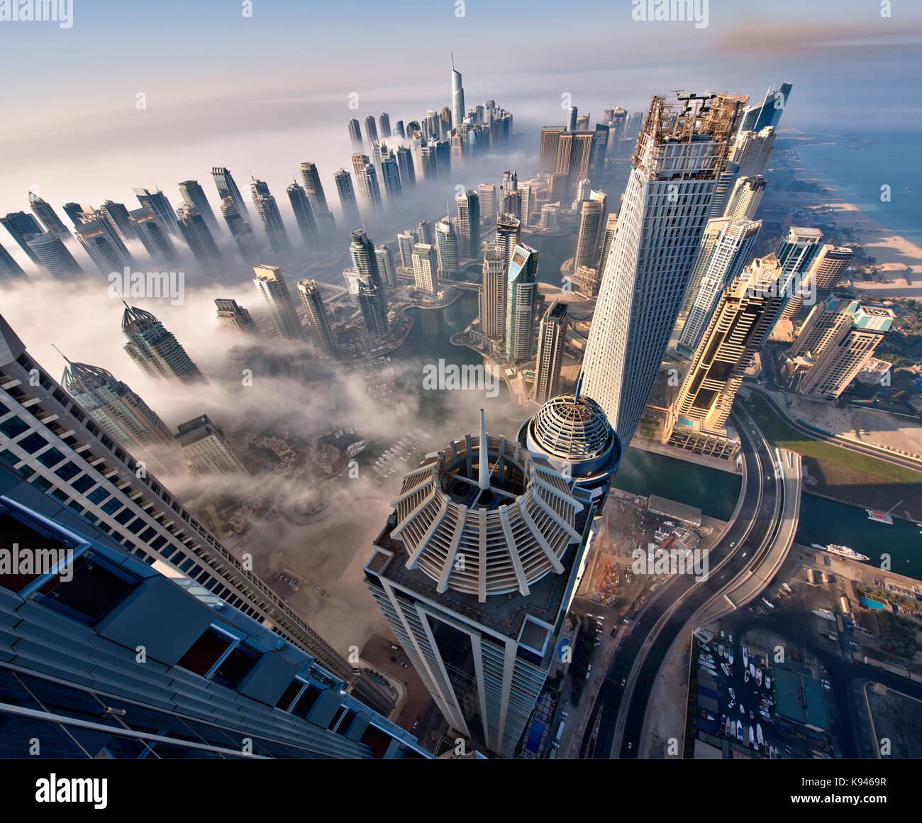 Aerial view of cityscape with skyscrapers above the clouds in Dubai ...