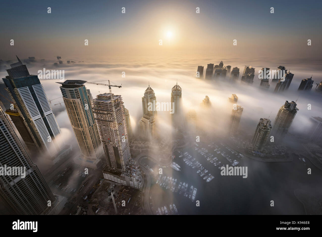 Aerial view of cityscape with skyscrapers above the clouds in Dubai ...