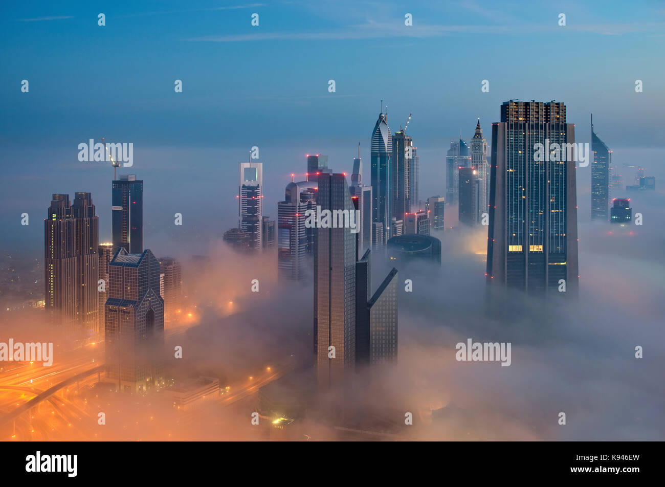 Cityscape with illuminated skyscrapers above the clouds in Dubai ...