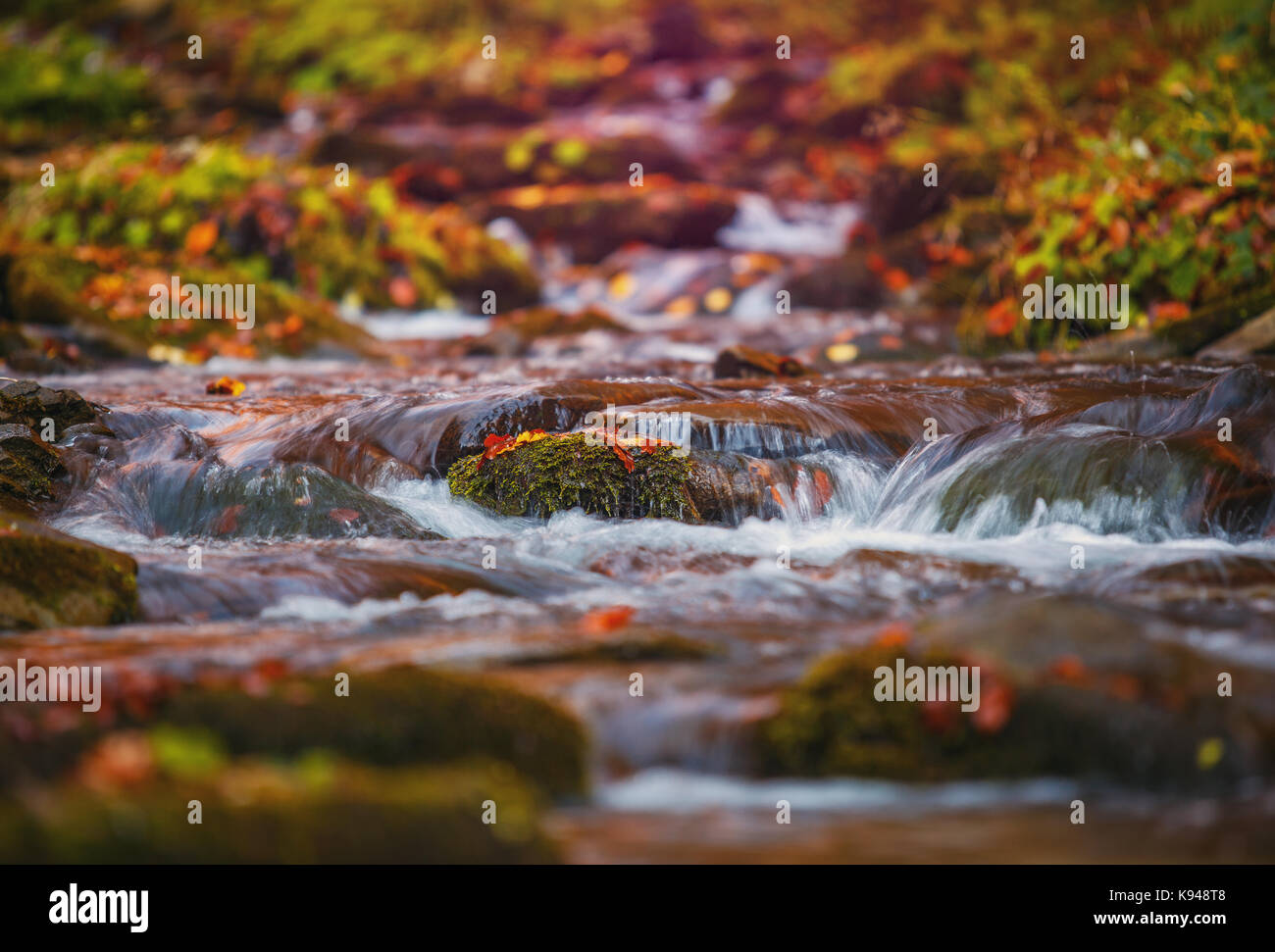 Blue water of mountain stream in autumn time Stock Photo - Alamy