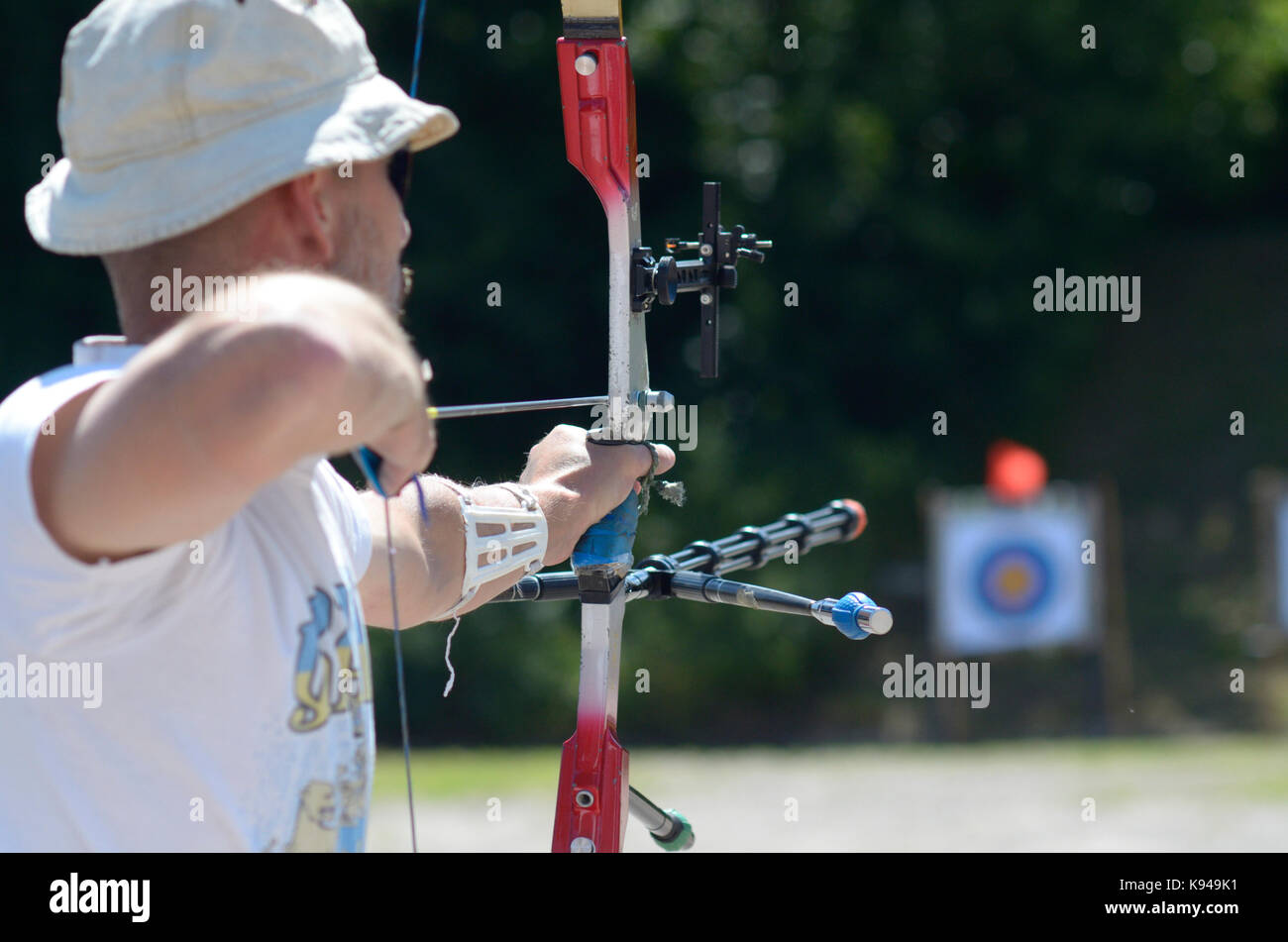 An archers aiming at archery target on a shooting range for archery ...