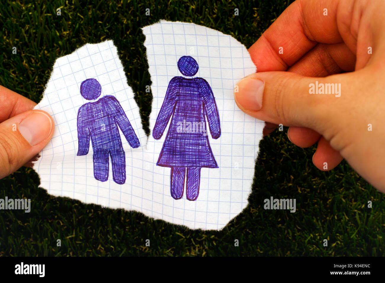 Woman hands ripping piece of paper with hand drawn man and woman ...
