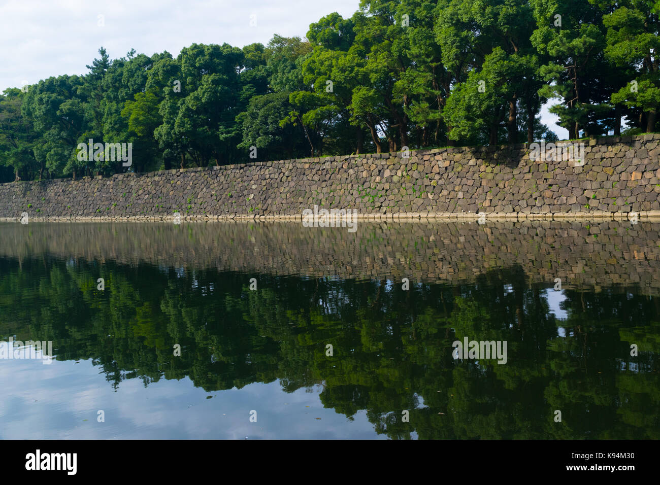Japanese castle wall with moat and trees Stock Photo - Alamy