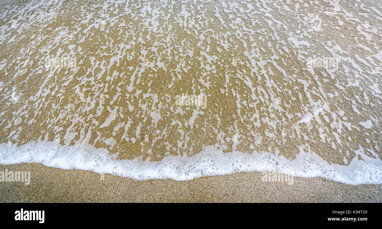 Small ocean sea waves on sandy beach in calm weather. Background ...
