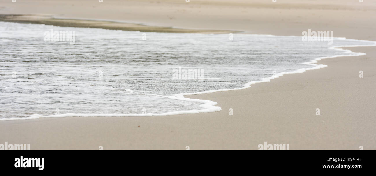 Small ocean sea waves on sandy beach in calm weather. Background ...