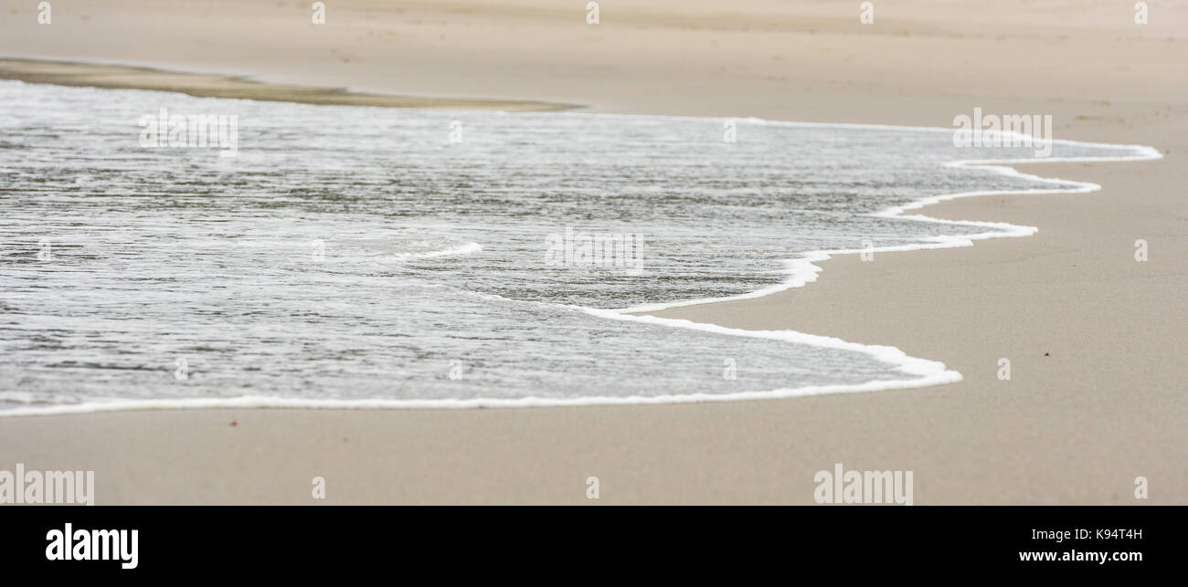 Small ocean sea waves on sandy beach in calm weather. Background ...