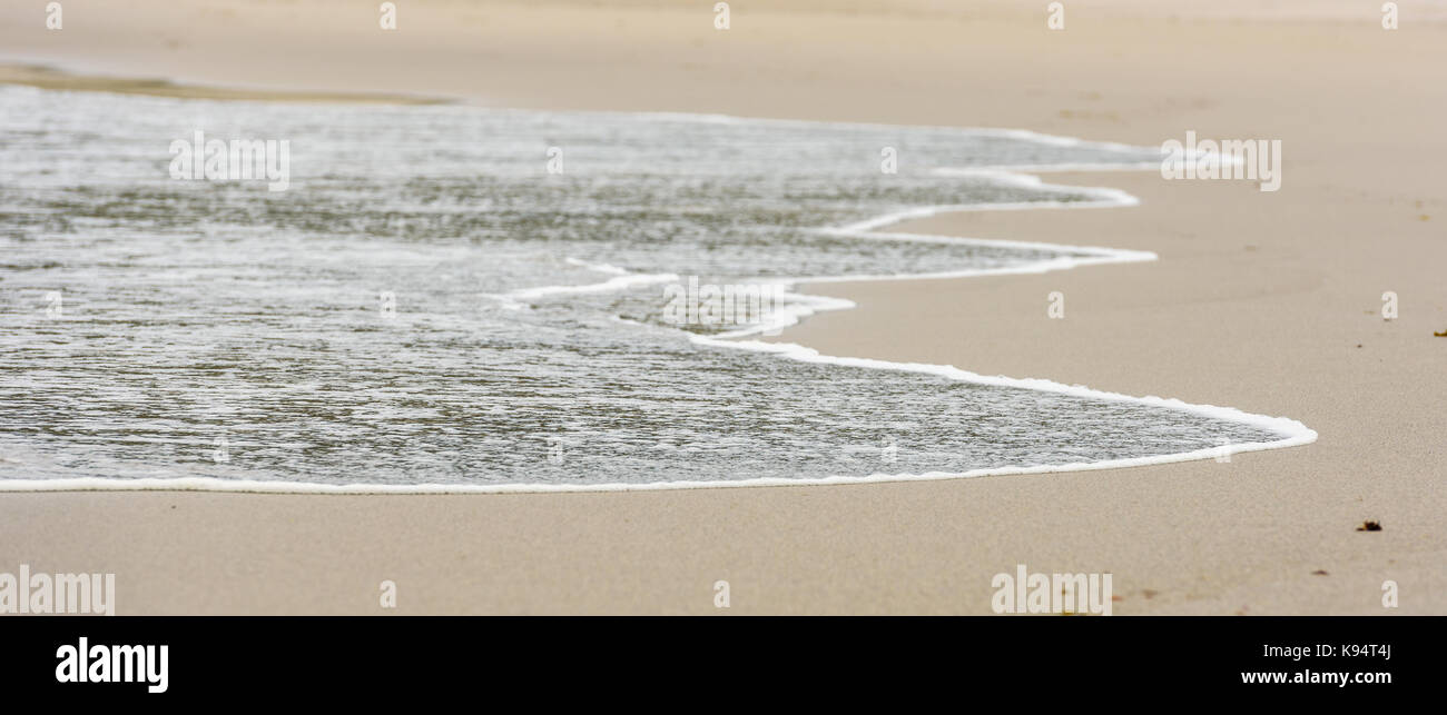 Small ocean sea waves on sandy beach in calm weather. Background ...